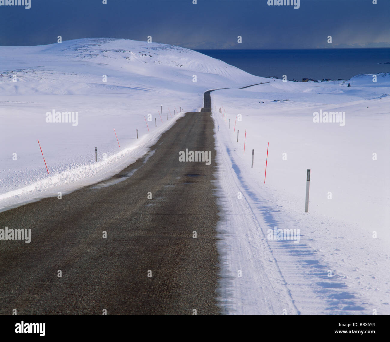Road by snow-covered landscape Stock Photo - Alamy