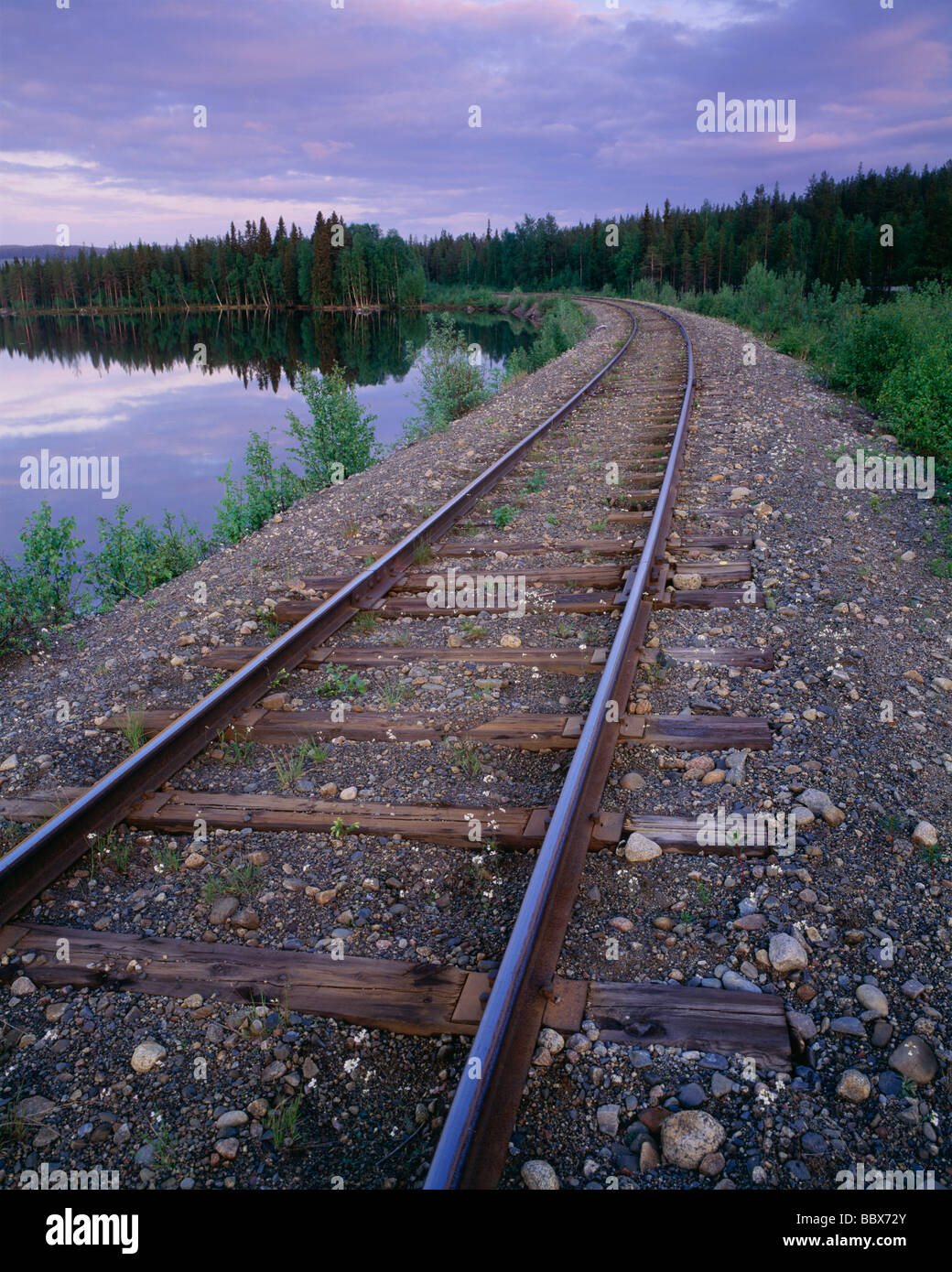 Railway tracks by lake Stock Photo - Alamy