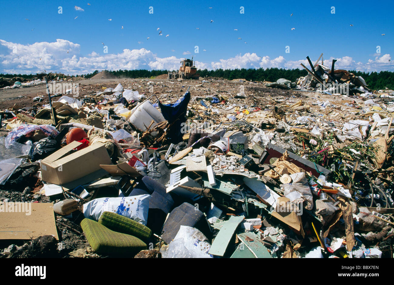 Garbage dump with bulldozer in background Stock Photo - Alamy