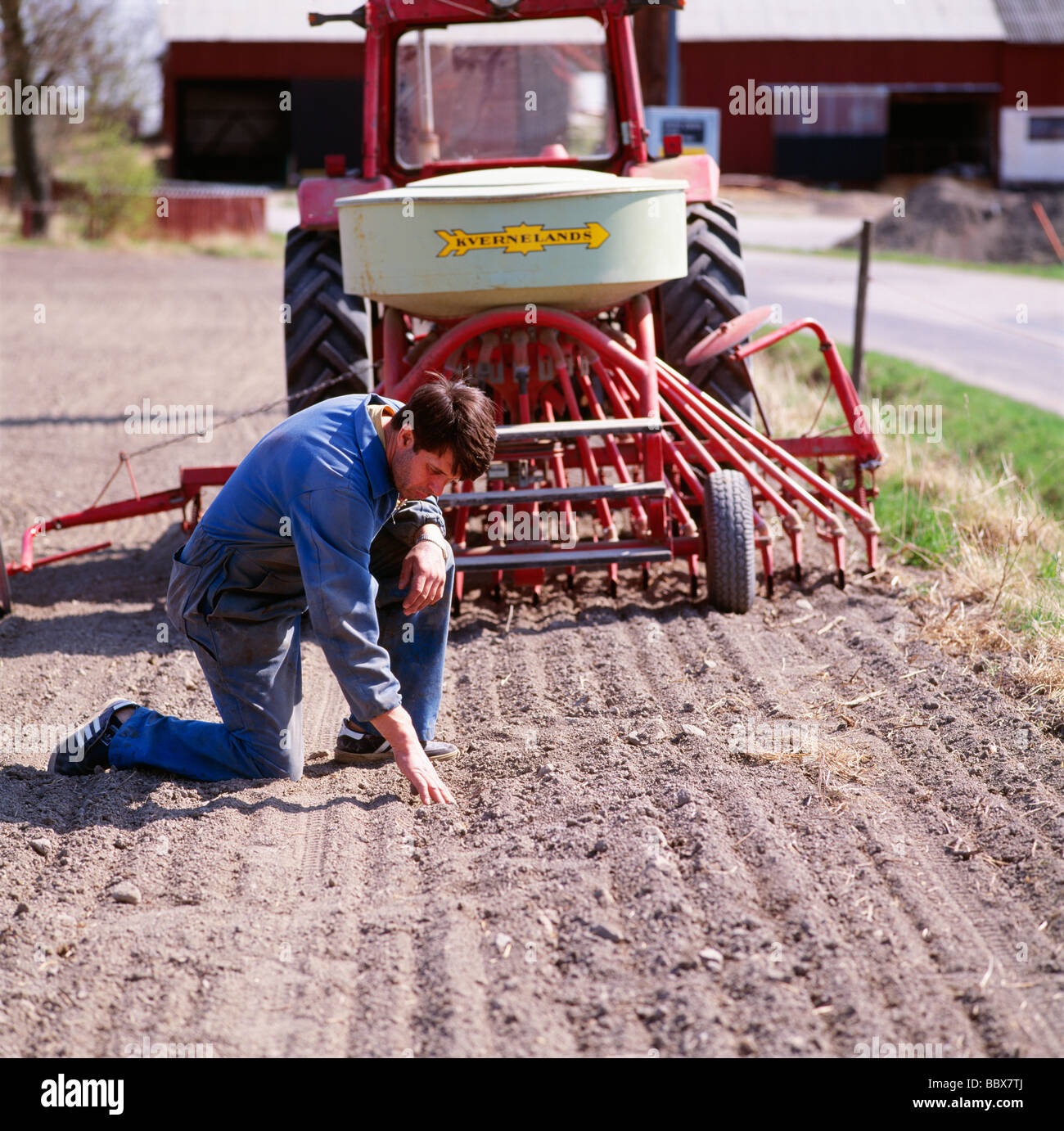 Mid adult man crouching on field Stock Photo - Alamy