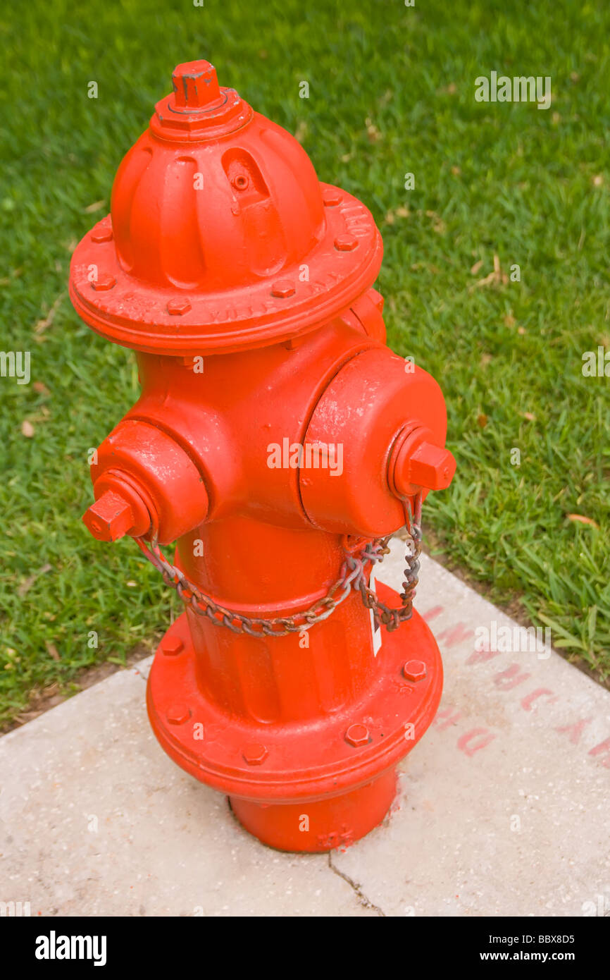 bright red fire hydrant against a green grass background Stock Photo ...