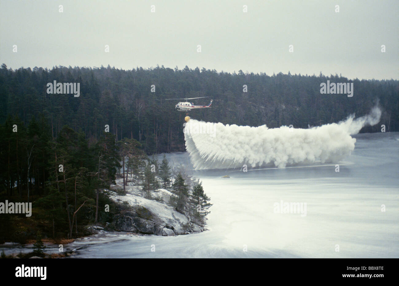 Helicopter flying over river Stock Photo - Alamy