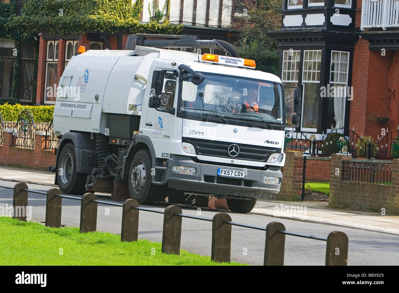 A road cleaning vehicle working in a residential street in the United ...