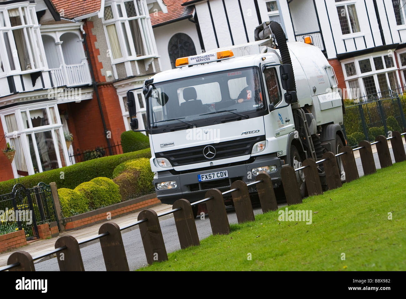 A road cleaning vehicle working in a residential street in the United ...
