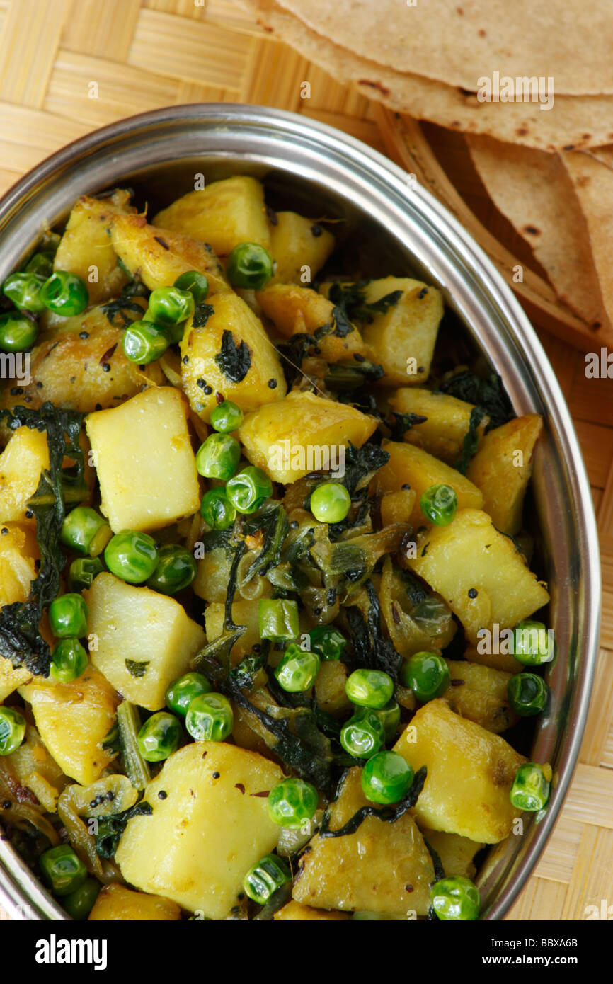 Saag Aloo Bhuna is prepared with the Cubes of potato cooked with tomato ...