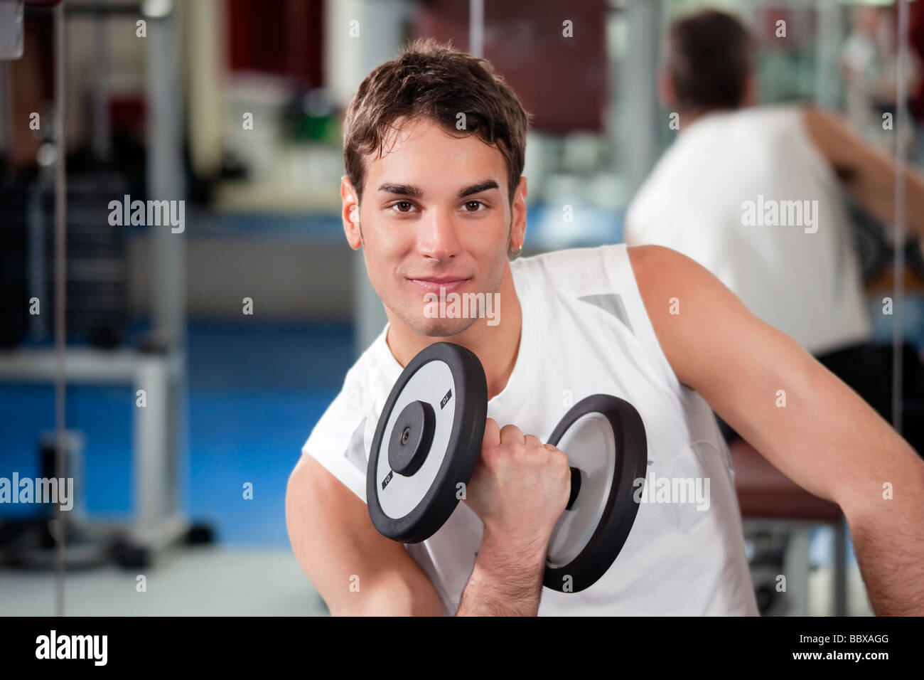 portrait of young man doing weightlifting in gym Stock Photo - Alamy