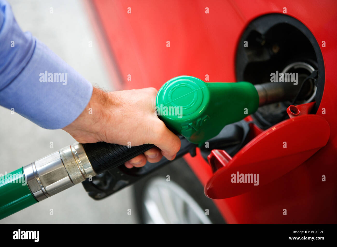 A man getting petrol into his red car Sweden Stock Photo - Alamy