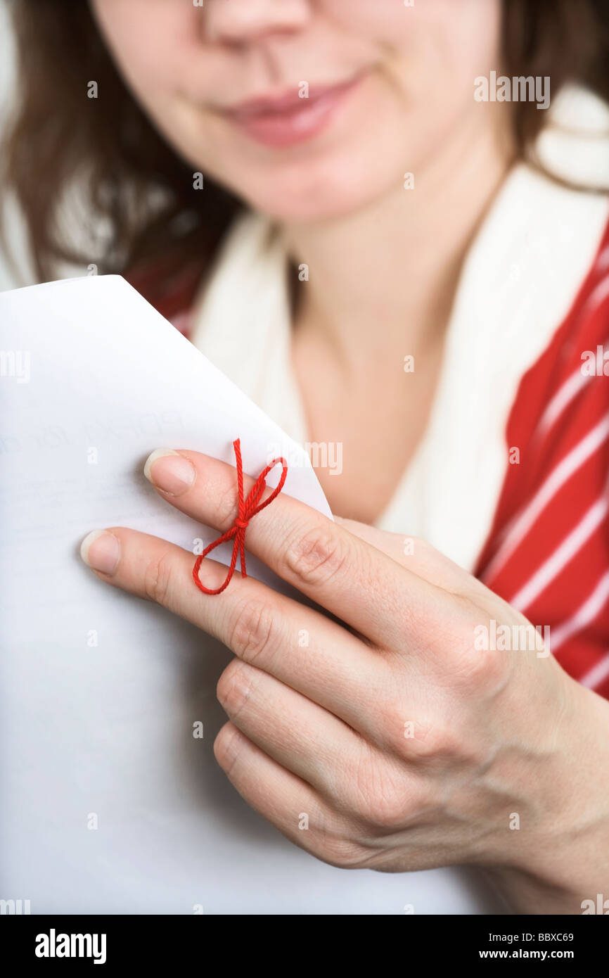 A hand with a thread tied around one finger to remember Sweden Stock ...