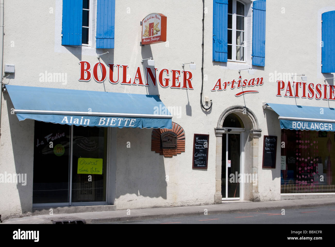 French boulangerie shop facade with shop windows, bread oven, blue ...