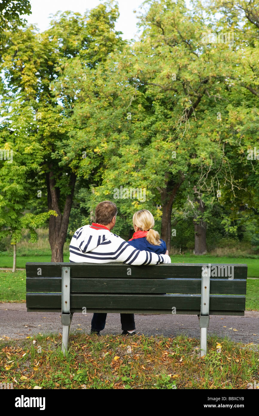 Two people sat on a park bench hi-res stock photography and images - Alamy