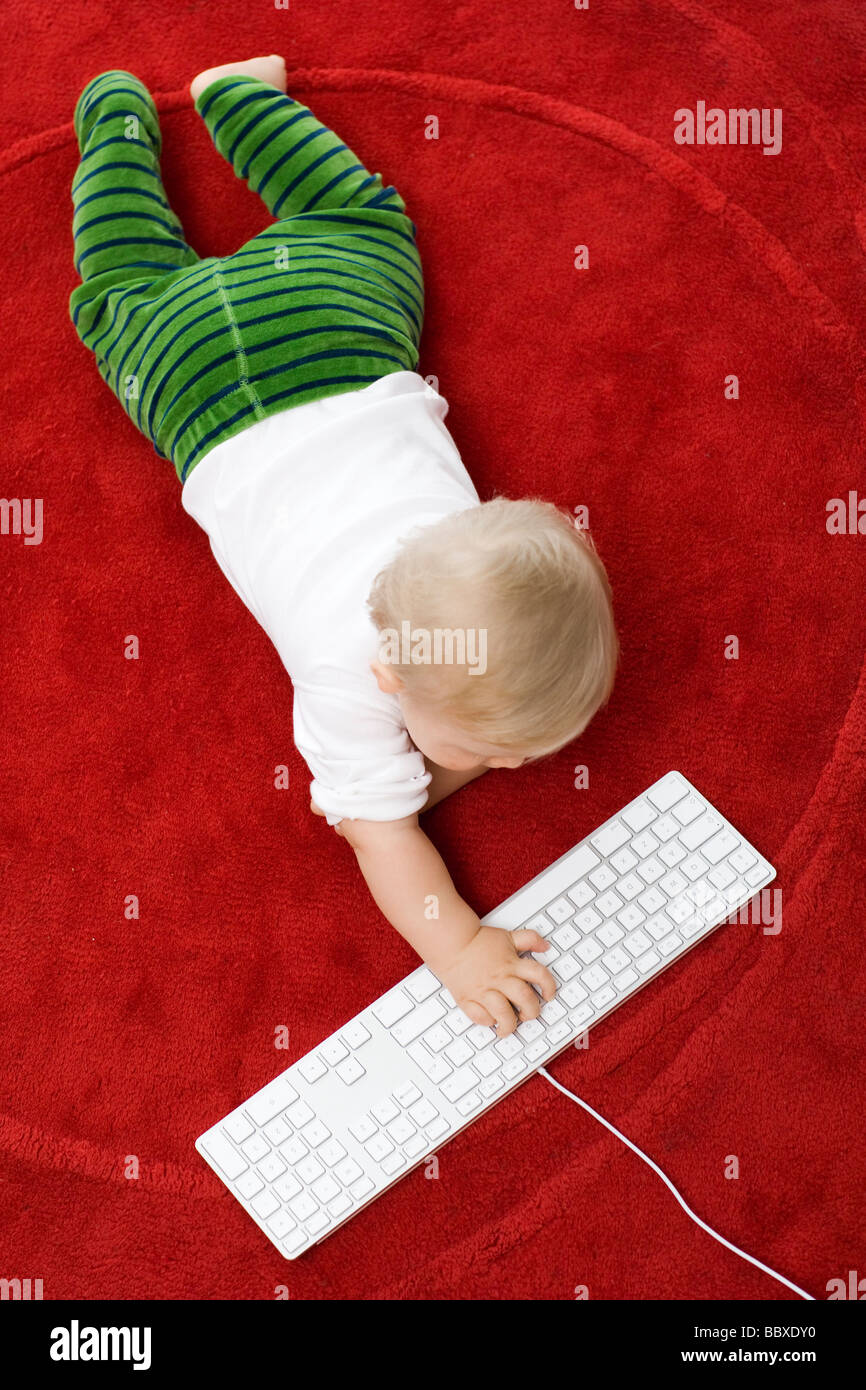 Baby playing with keyboard Stock Photo - Alamy