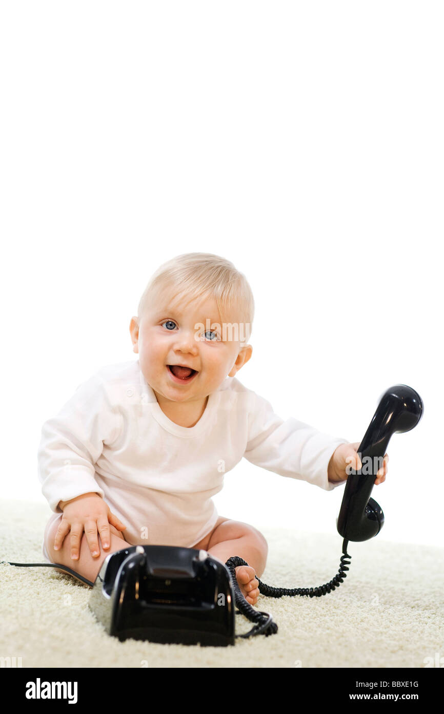 Baby playing with a telephone Stock Photo - Alamy