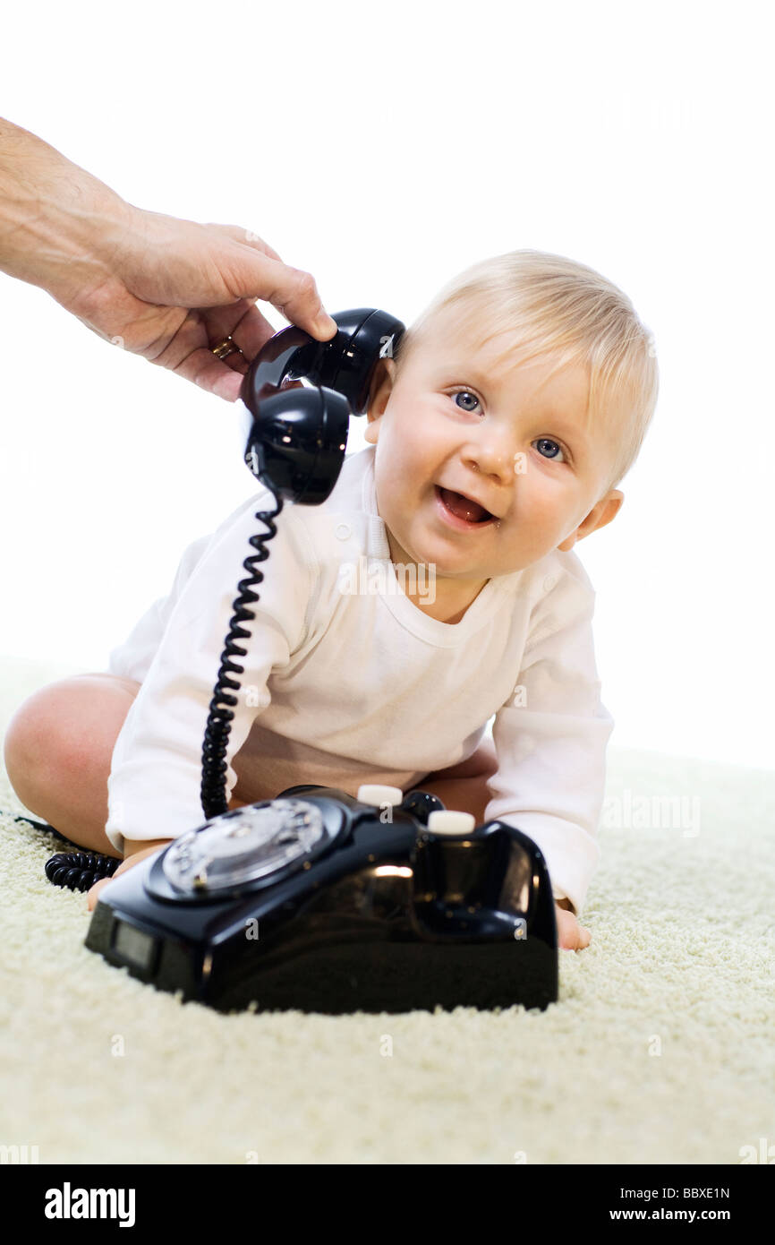 Baby playing with a telephone Stock Photo - Alamy