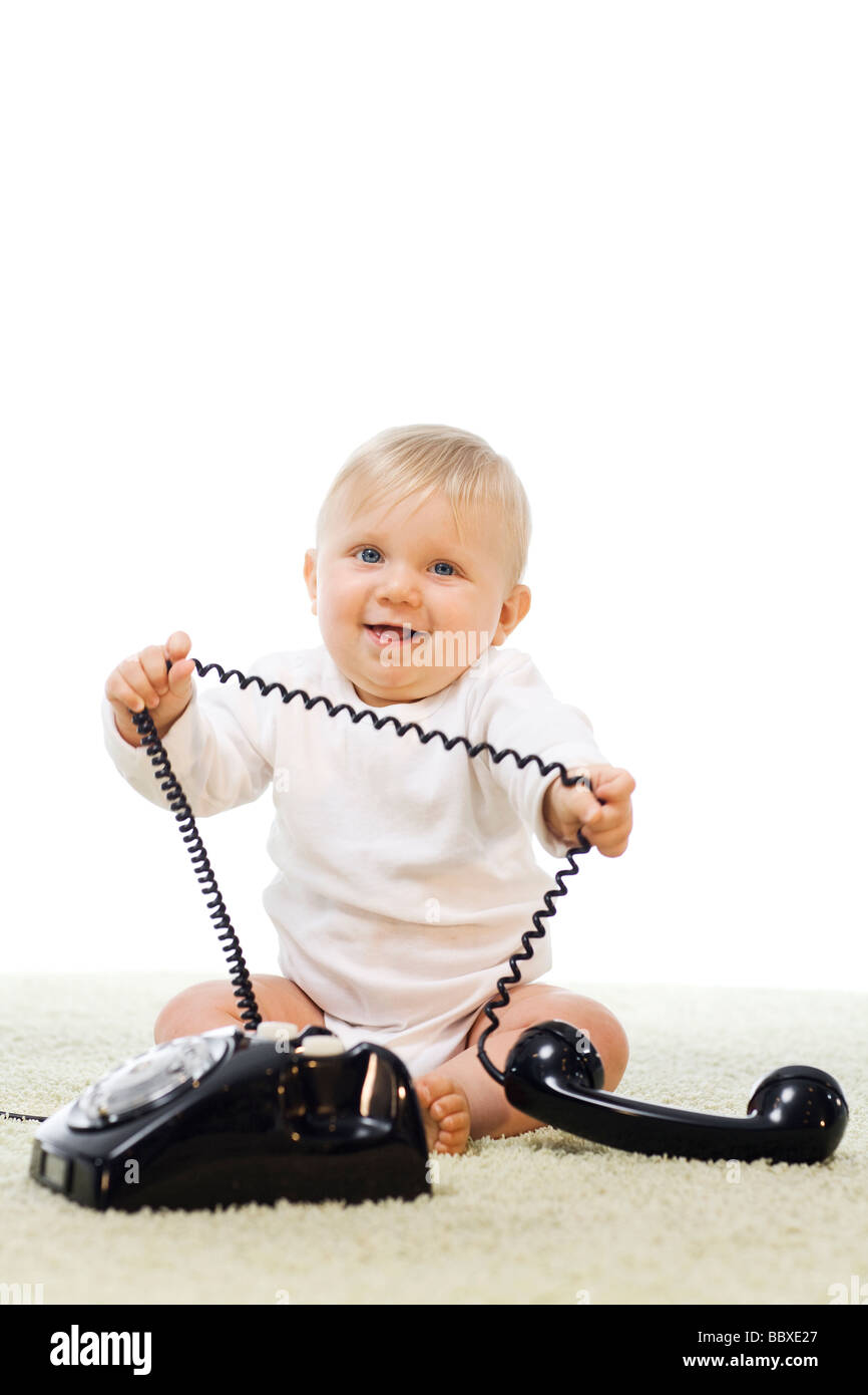 Baby playing with a telephone Stock Photo - Alamy
