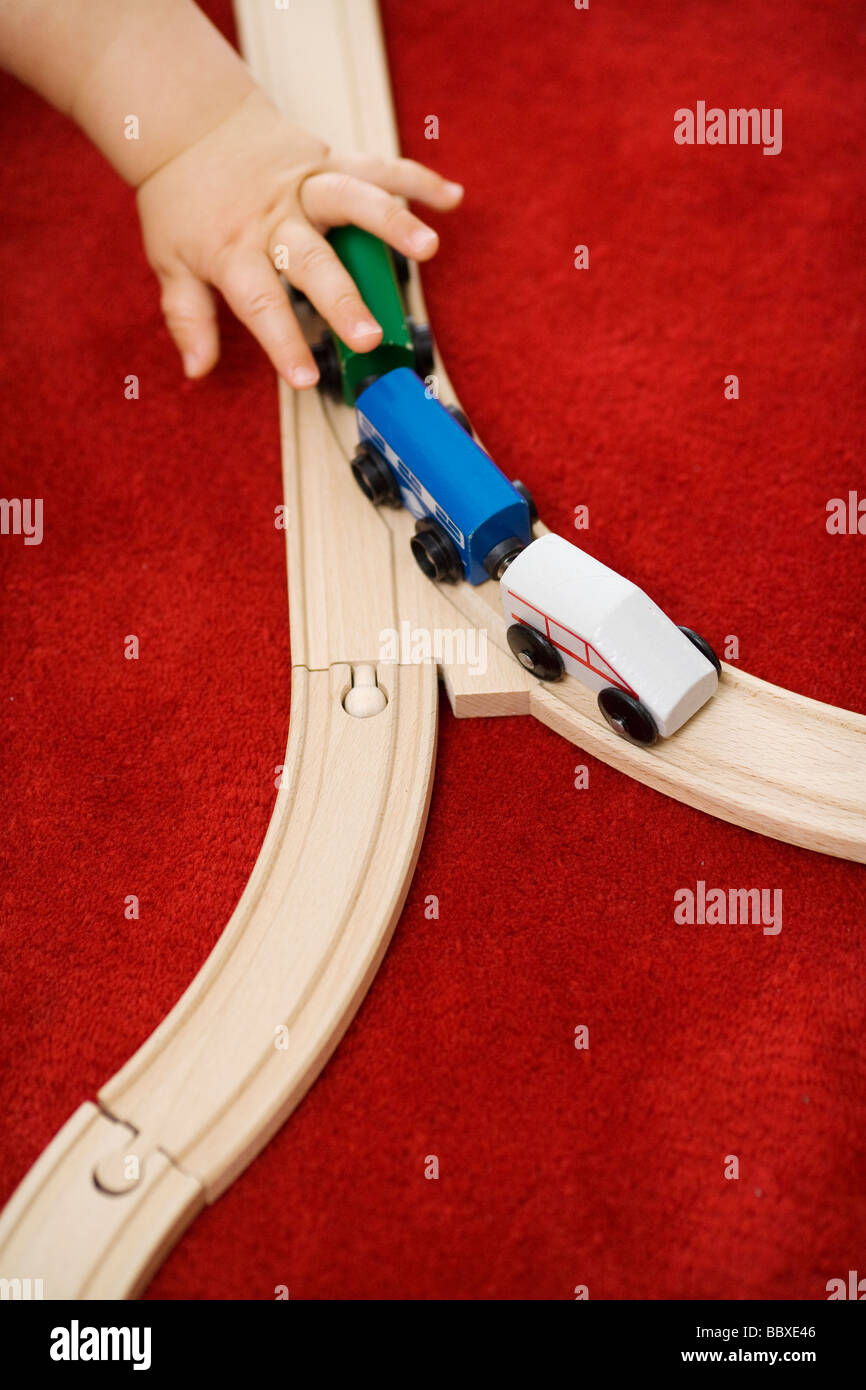 A baby playing with a train Stock Photo - Alamy