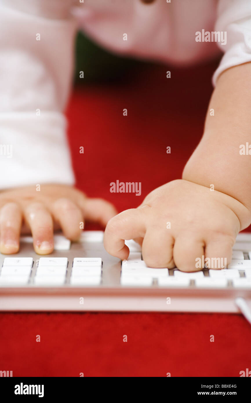 Baby playing with keyboard Stock Photo - Alamy