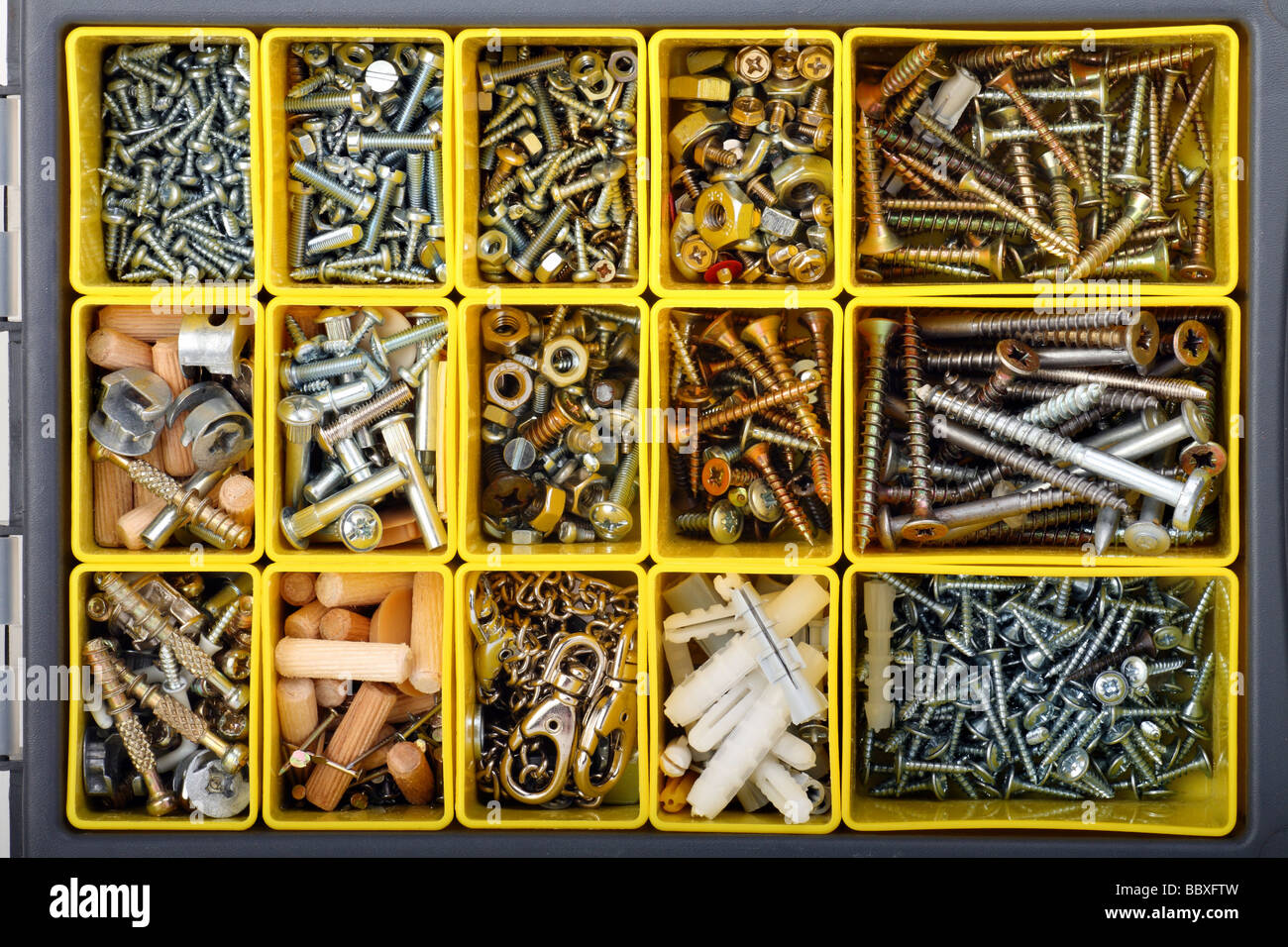 Screws, bolts, wall plugs, nuts and other carpenter stuff in a yellow ...
