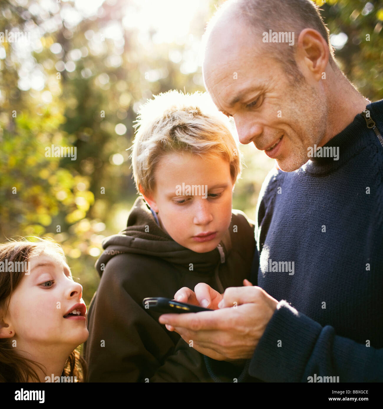 Man and two children in the forest Sweden Stock Photo - Alamy
