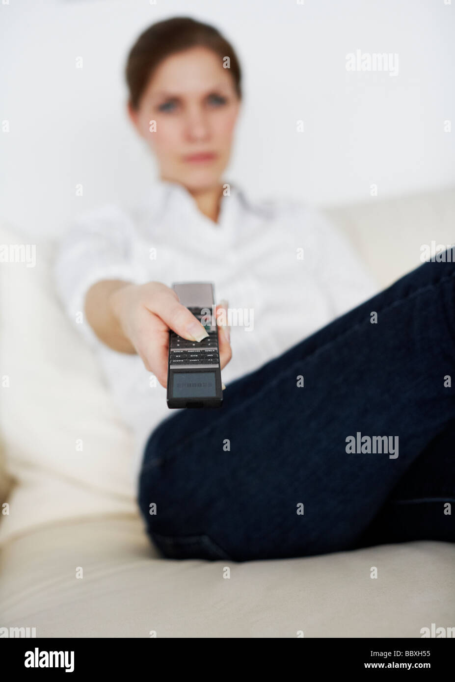 A woman using a remote control Sweden Stock Photo - Alamy