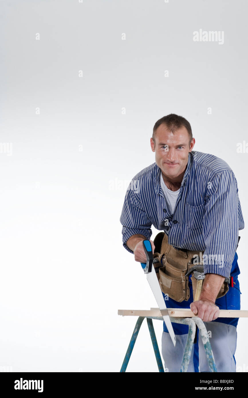 A carpenter using a saw Stock Photo - Alamy