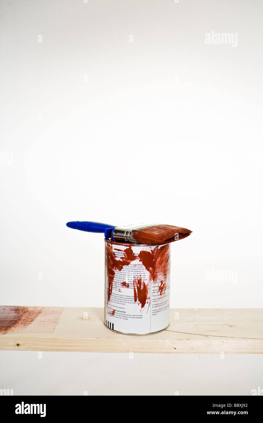 Paintbrush red paint and a paint bottle Stock Photo - Alamy