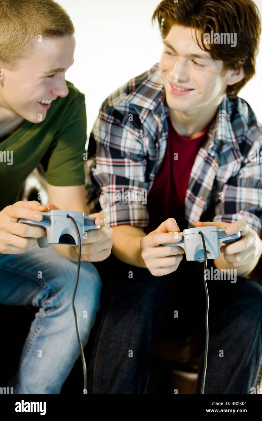 Two teenagers playing a video game Stock Photo - Alamy