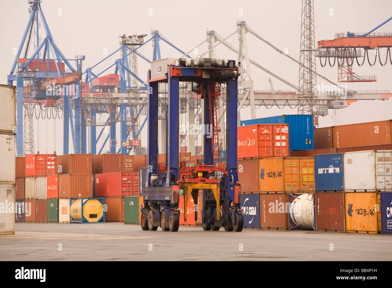 A straddle carrier truck moves ISO containers around the container ...