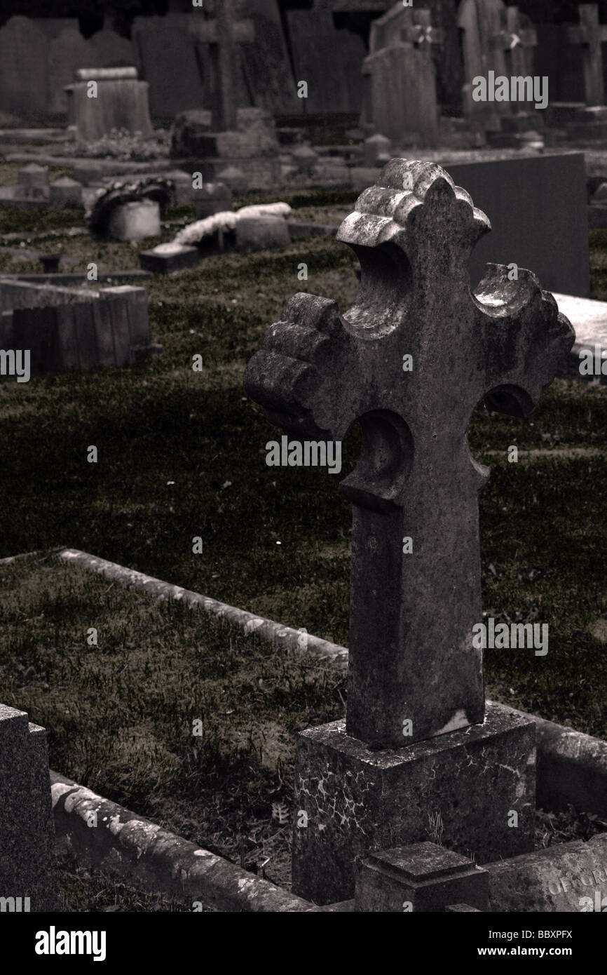 A crucifix gravestone in a church graveyard Stock Photo - Alamy