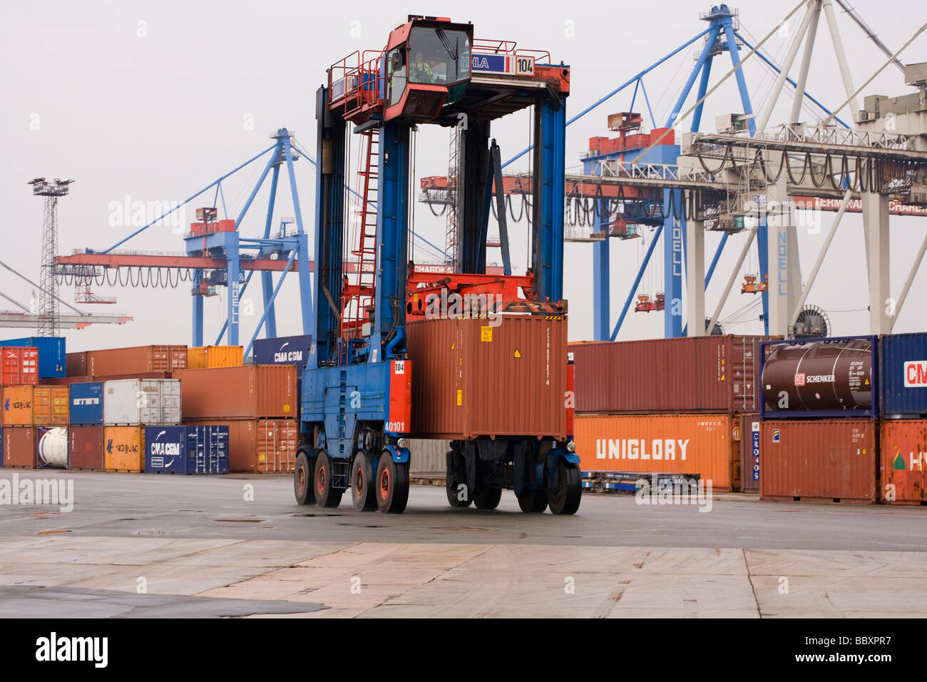 A straddle carrier truck moves ISO containers around the container ...