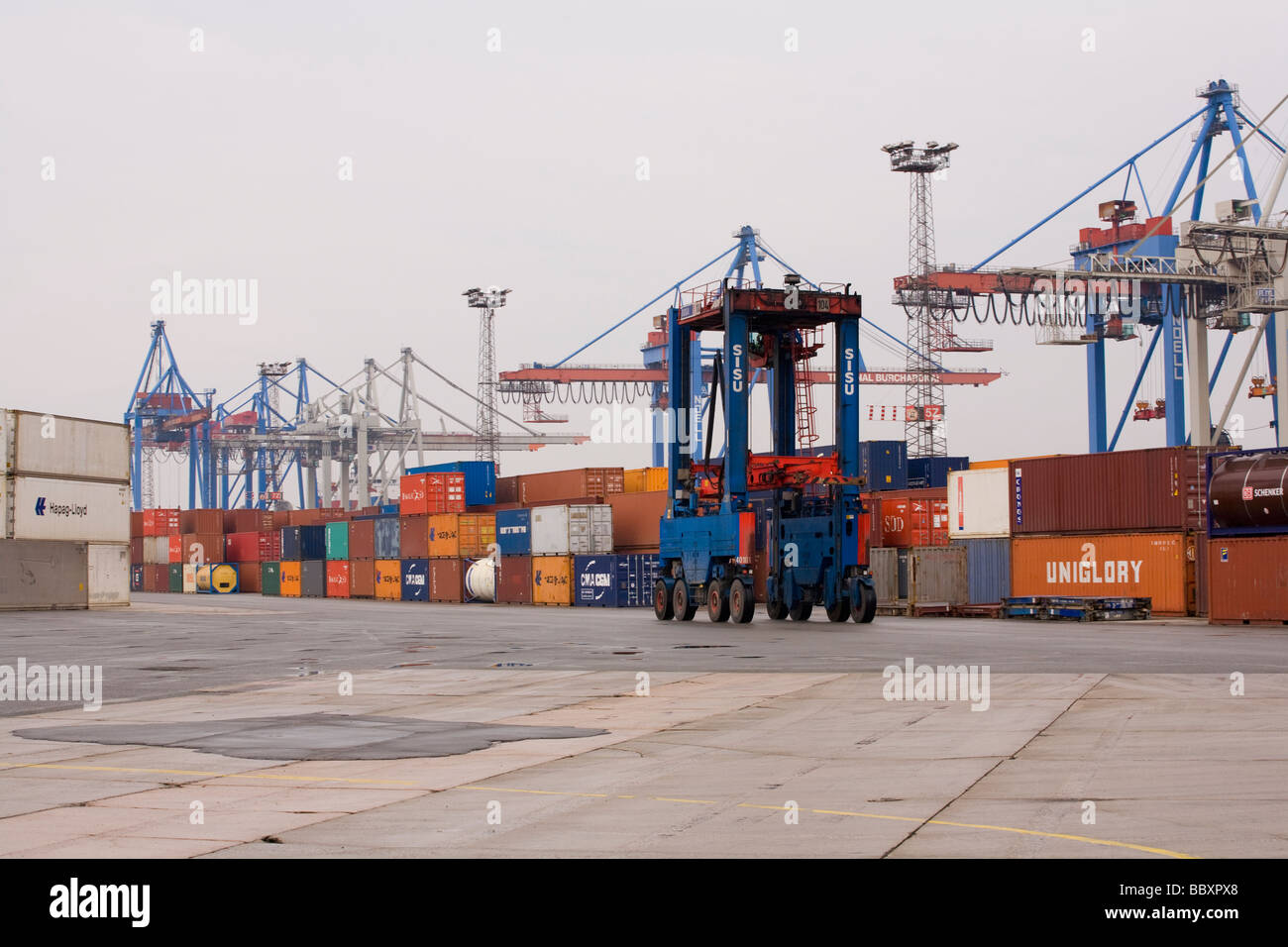 A straddle carrier truck moves ISO containers around the container ...