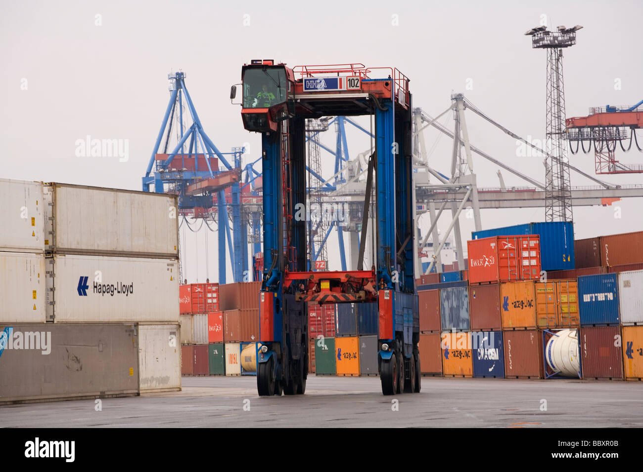 A straddle carrier truck moves ISO containers around the container ...