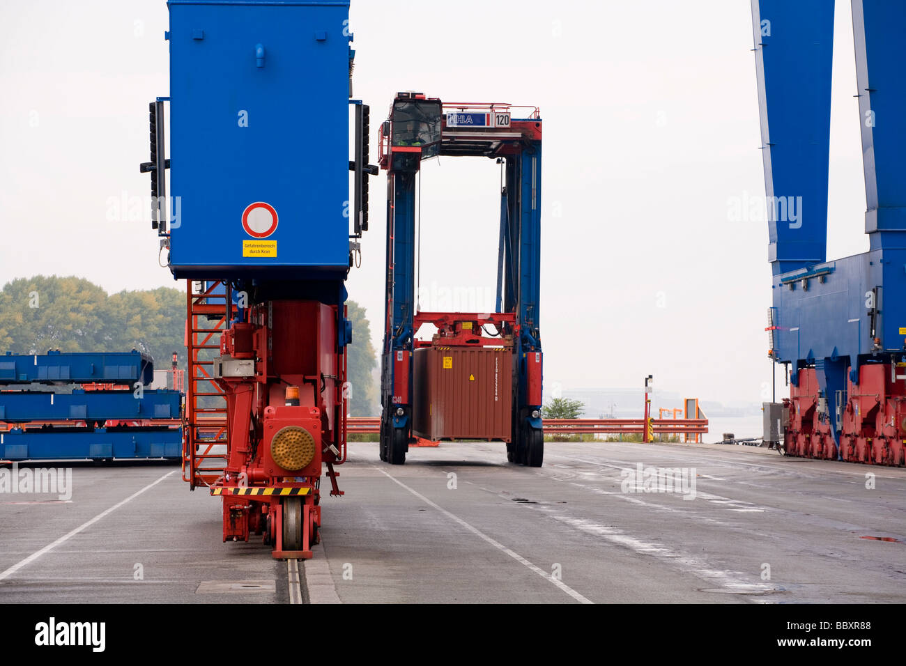 A straddle carrier truck moves ISO containers from dockside terminals ...