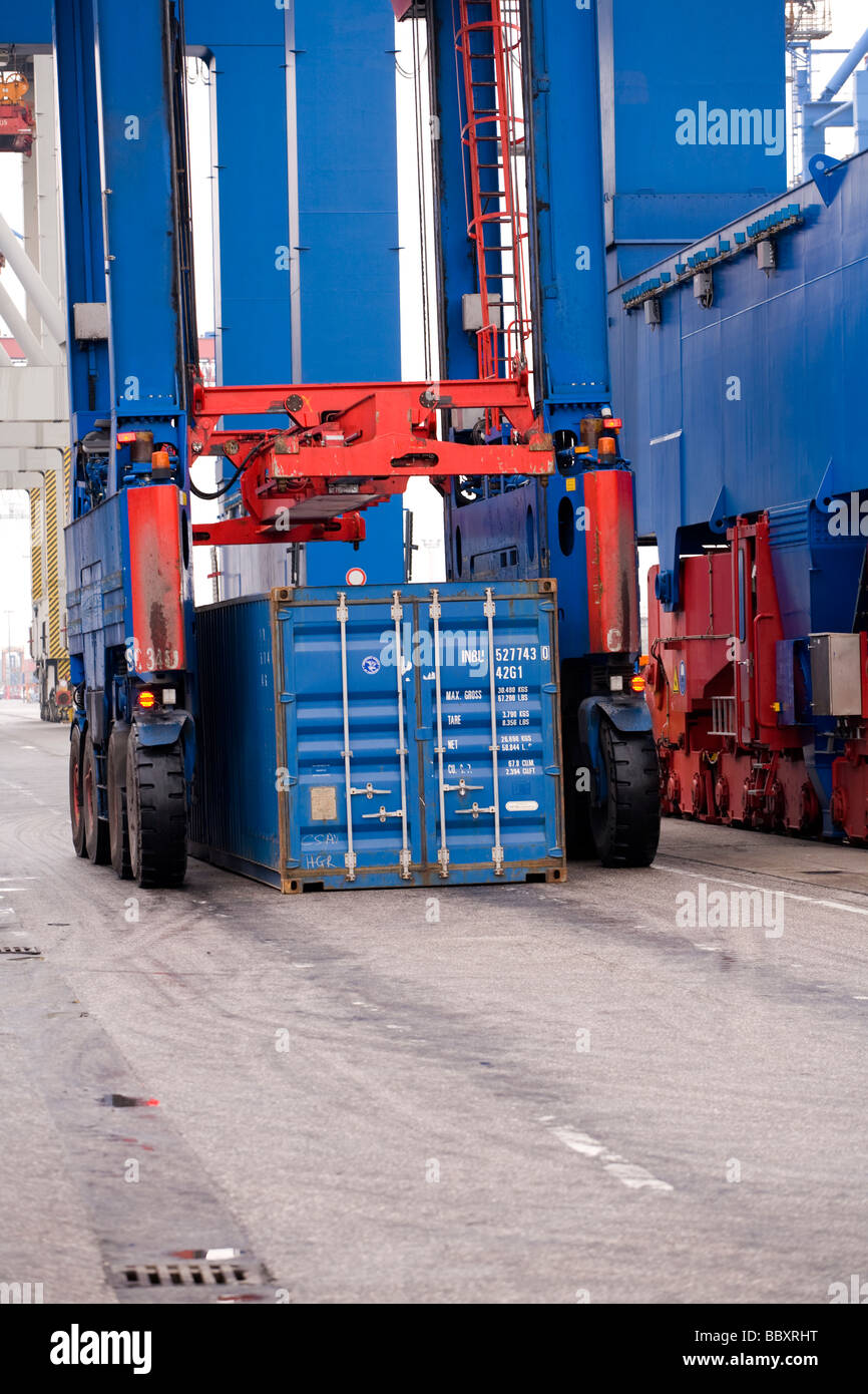 A straddle carrier truck moves ISO containers from dockside terminals ...