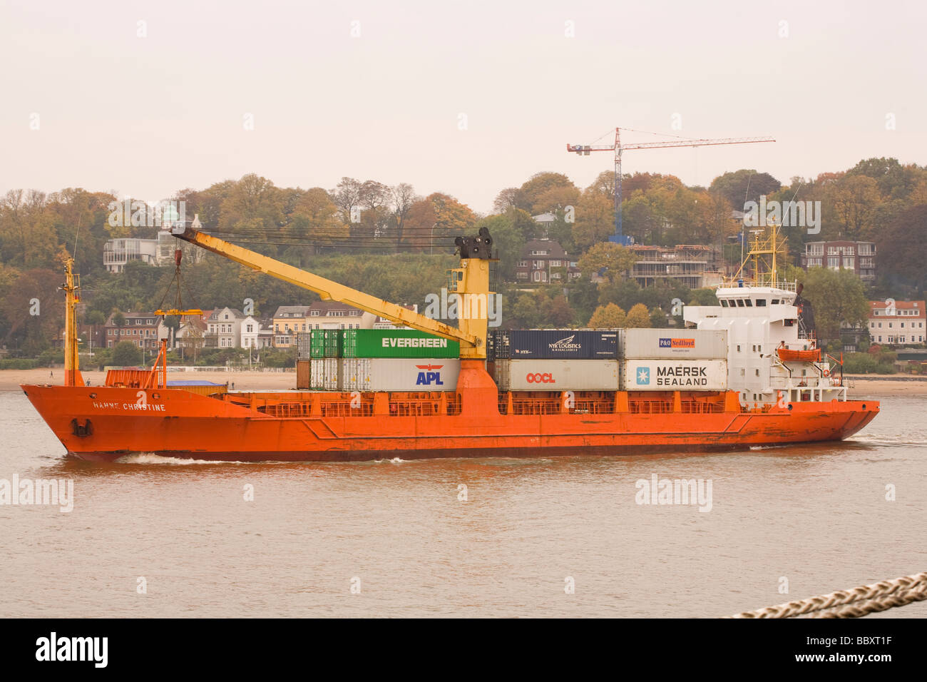 A small to medium size container ship heads out to see along the Elbe ...
