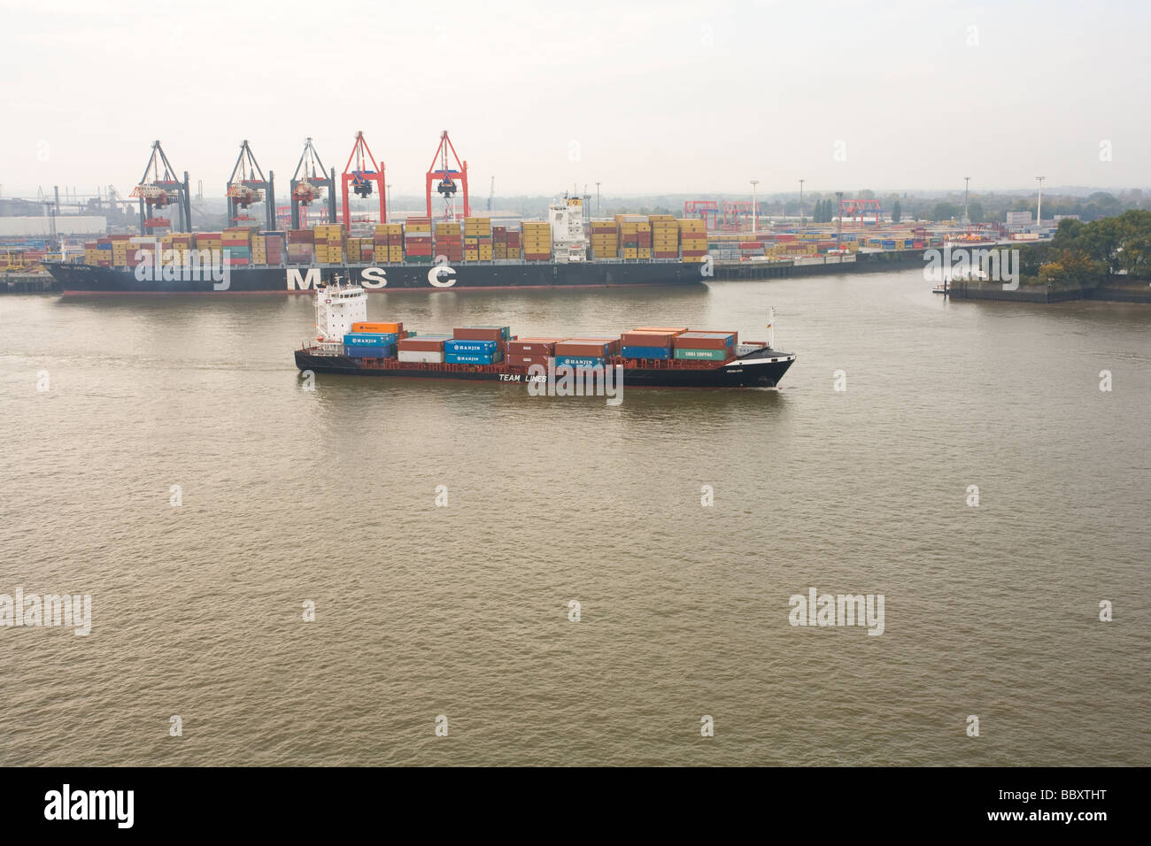 A small to medium size container ship heads out to see along the Elbe ...