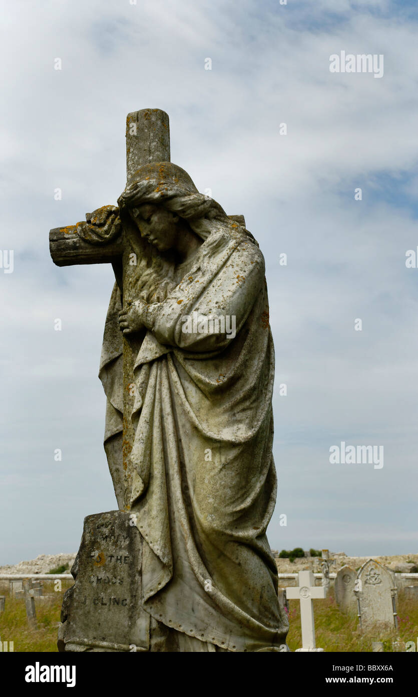 Statue with cross Stock Photo - Alamy