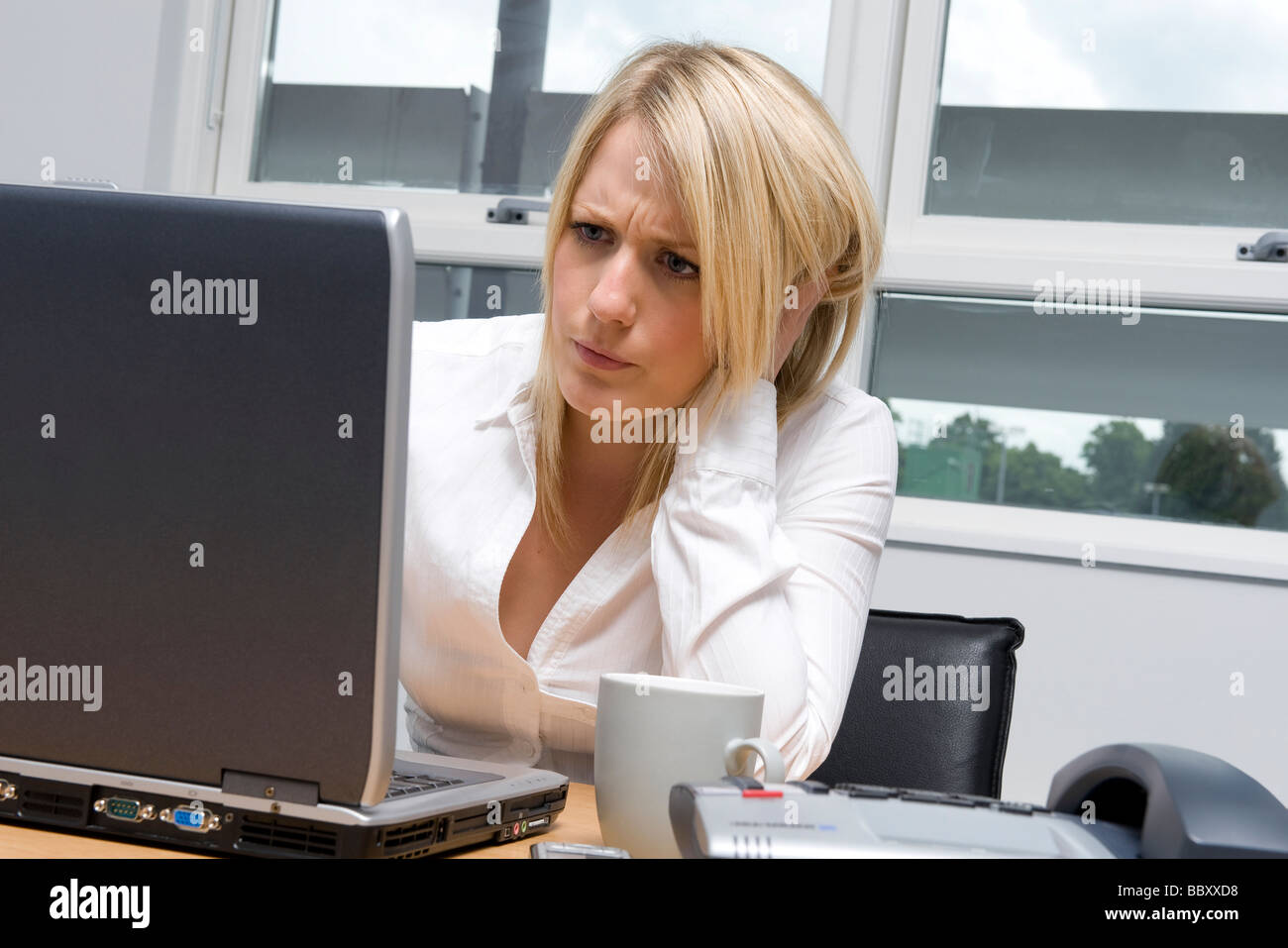 Office worker using computer concerned hi-res stock photography and ...
