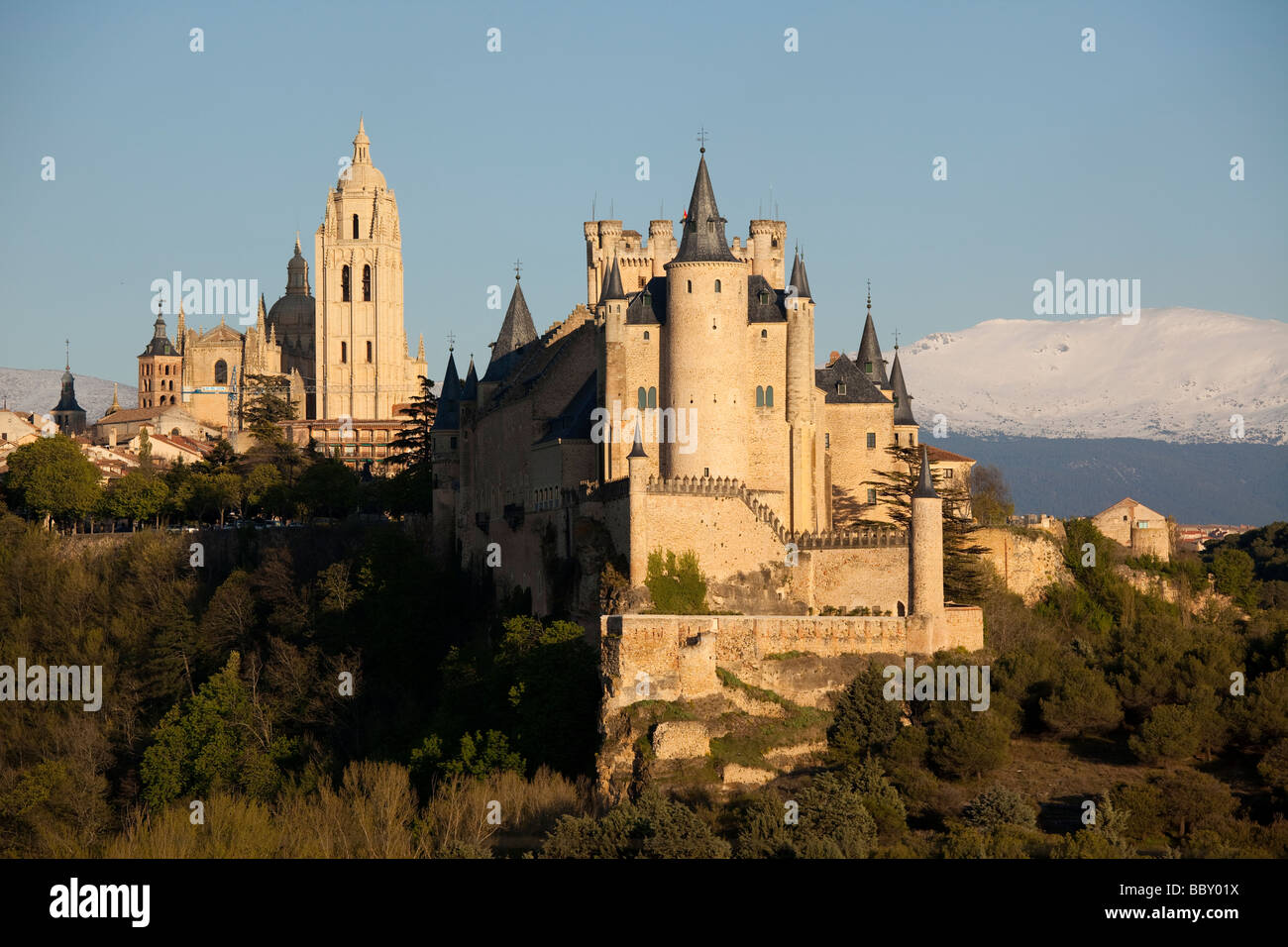 Segovia castle and Cathedral surounded by snow capped mountains ...