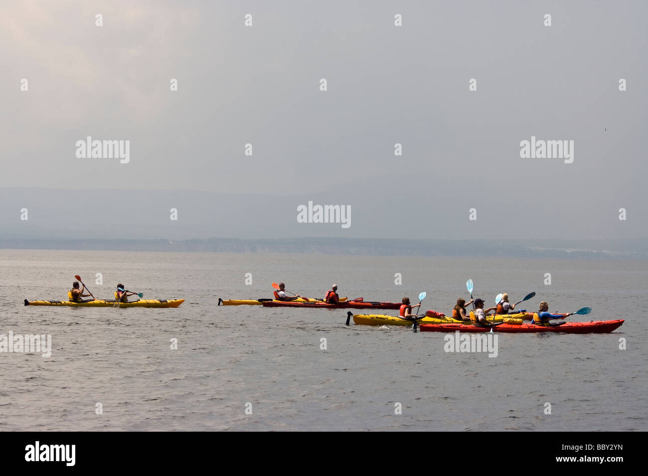 Group of kayaks/canoes people paddling in the golf of Saint Lawrence ...