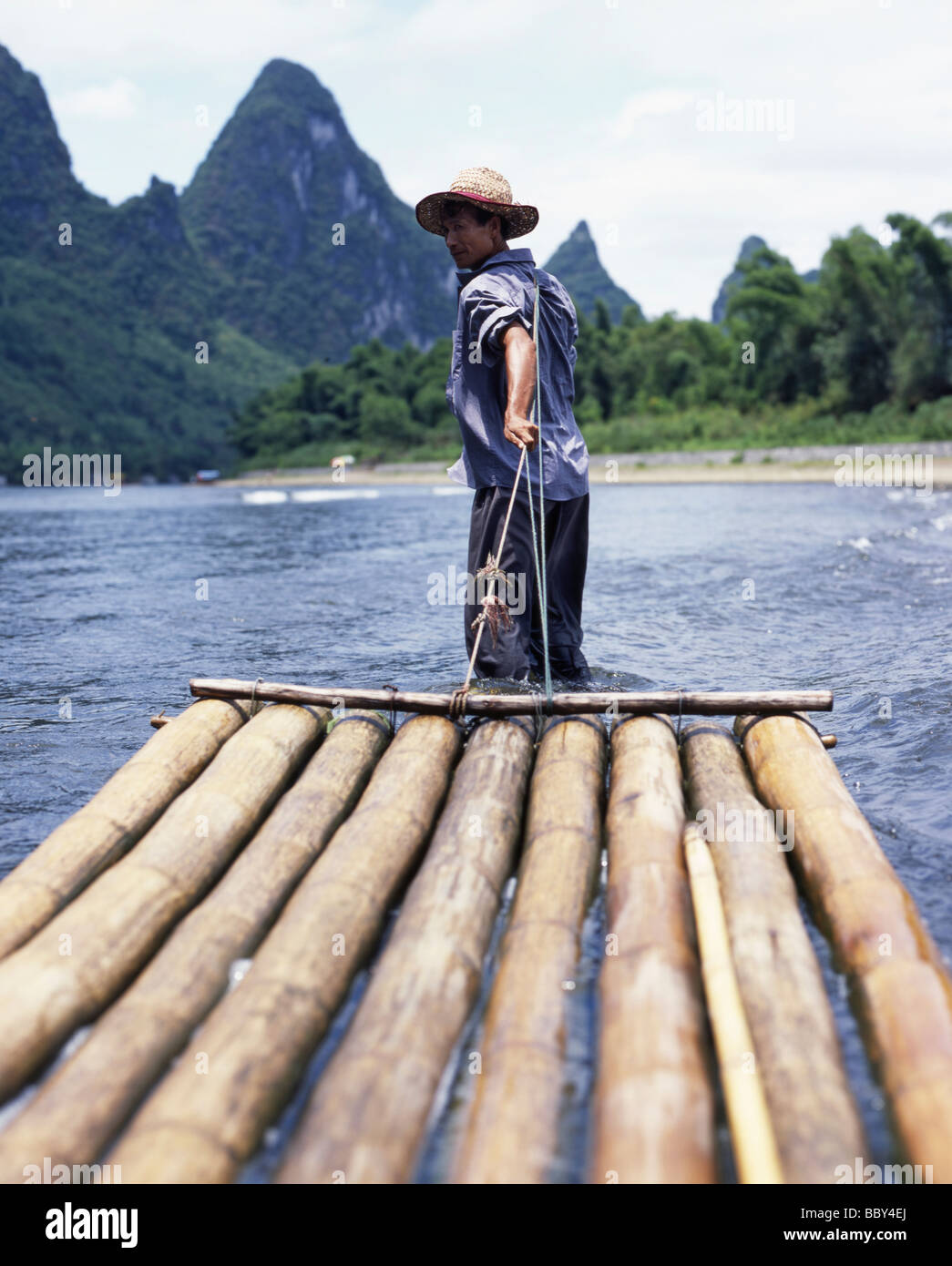 A fisherman pulls his bamboo raft on the Li River, China Stock Photo ...