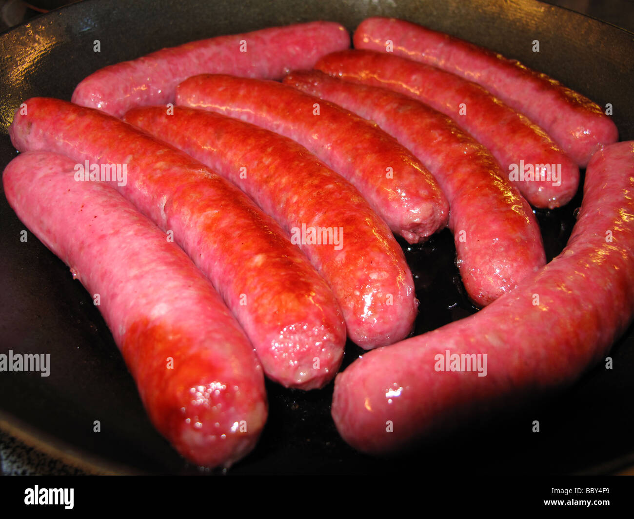Beef link sausages in frying pan Stock Photo - Alamy