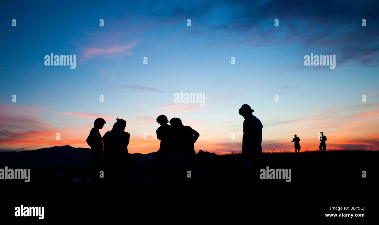 Group of people at sunset Stock Photo - Alamy