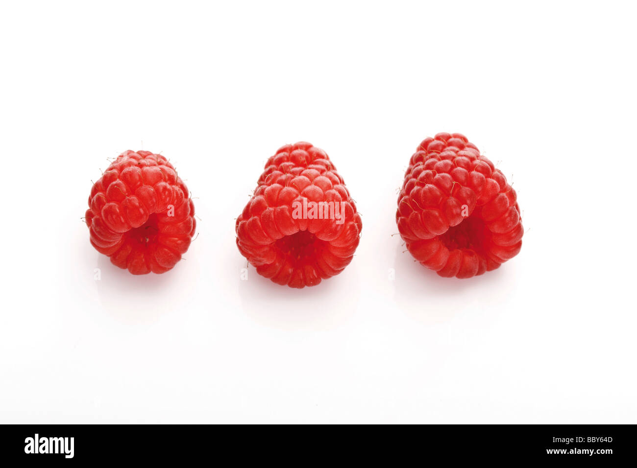 Three raspberries, side by side Stock Photo - Alamy