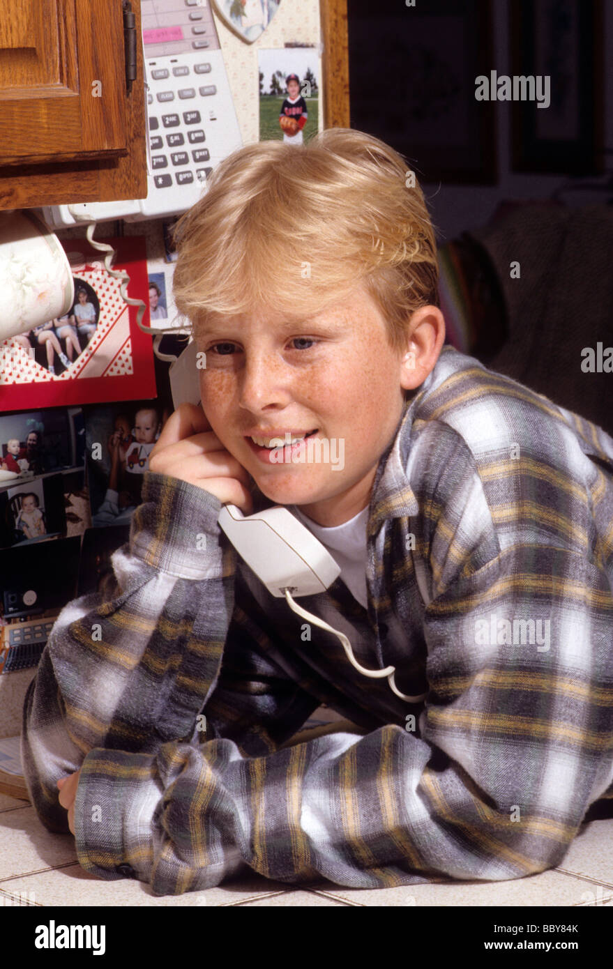 blond boy call phone telephone serious talk conversation message listen ...