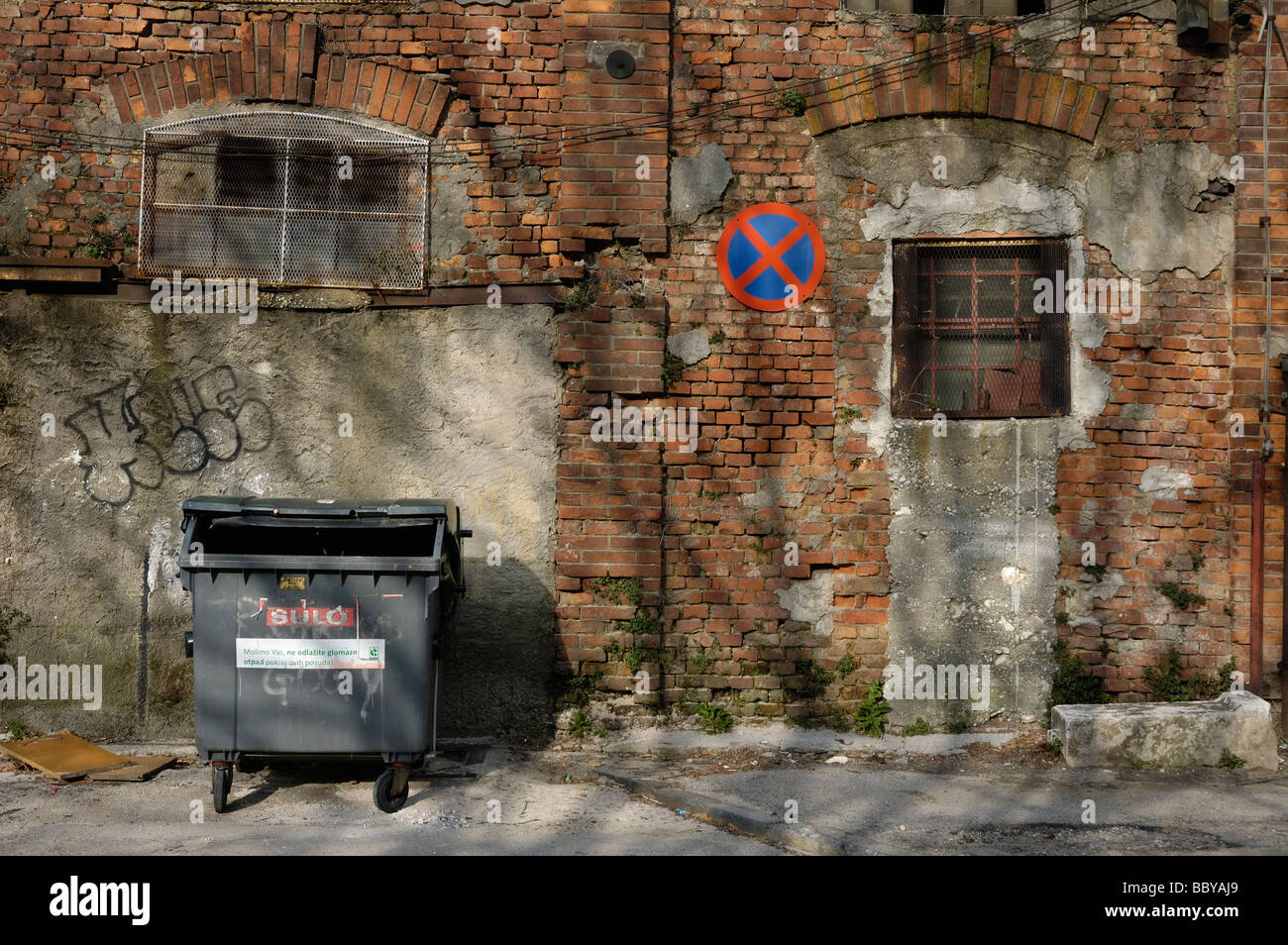 Street scene trash bin and no stopping traffic sign in front abandoned ...