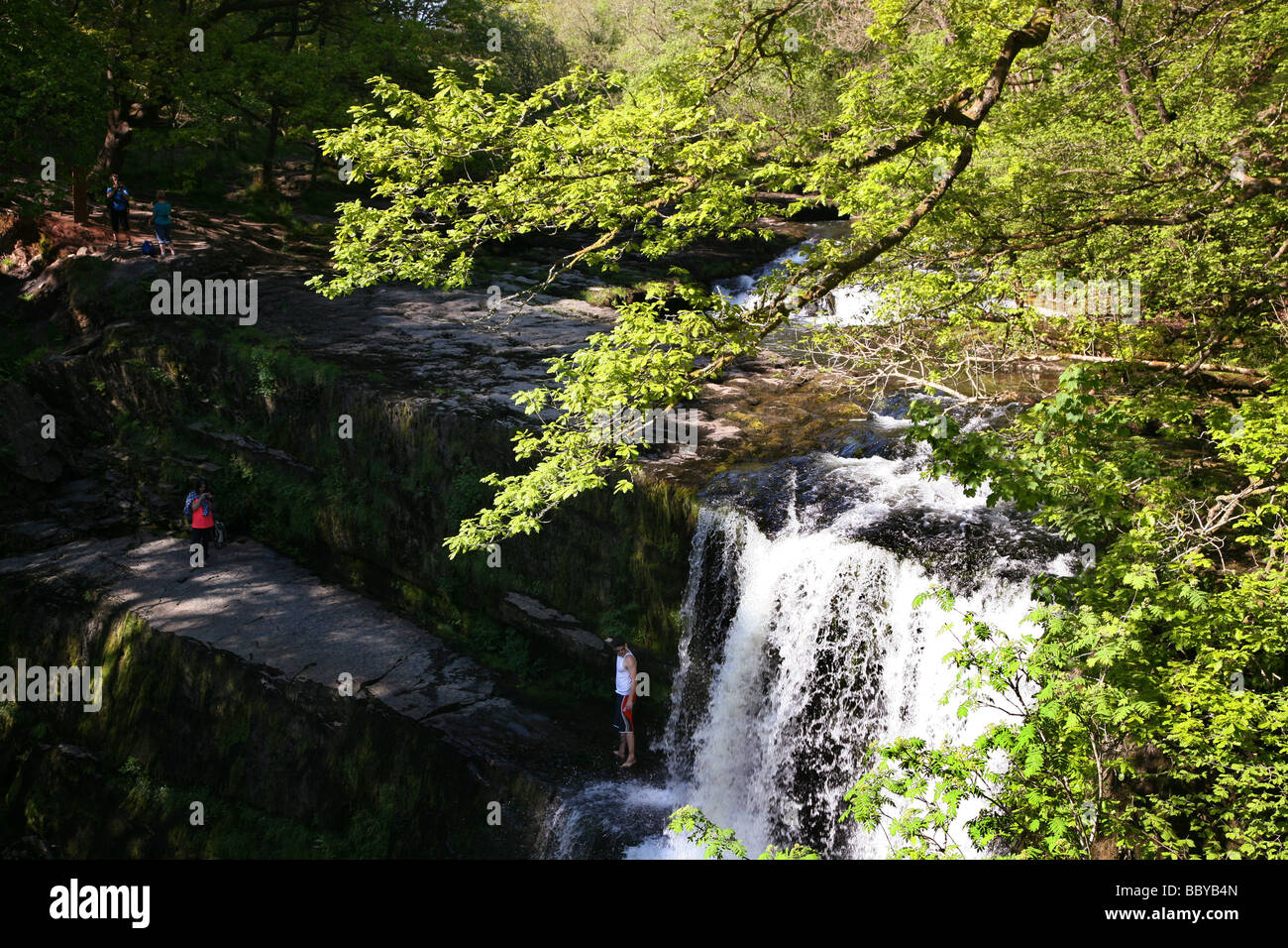 Visitors beside the Sqwd-Clun-Gwyn waterfall on the River Mellte near ...