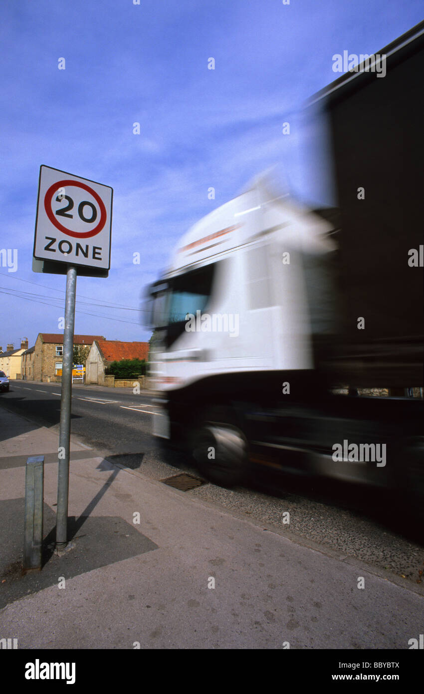 lorry passing 20 miles per hour speed limit zone warning sign on road ...