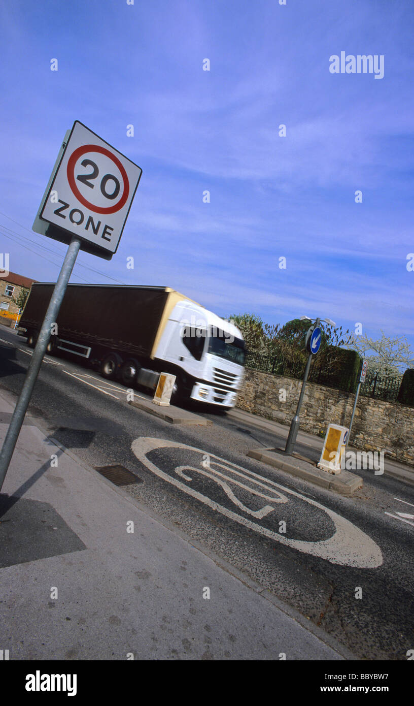 lorry passing 20 miles per hour speed limit zone warning sign on road ...