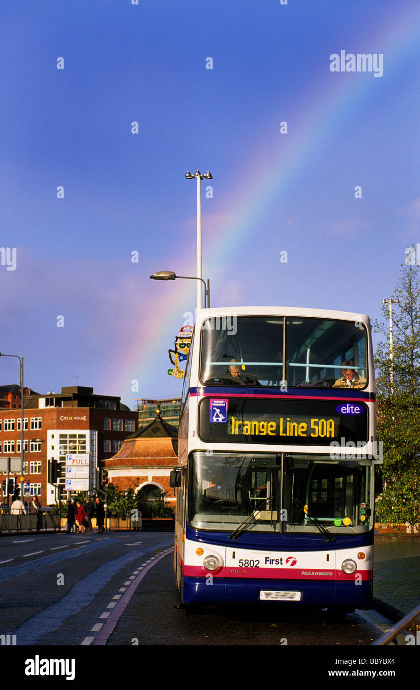 bus waiting at bus stop in the city of Leeds with rainbow overhead ...