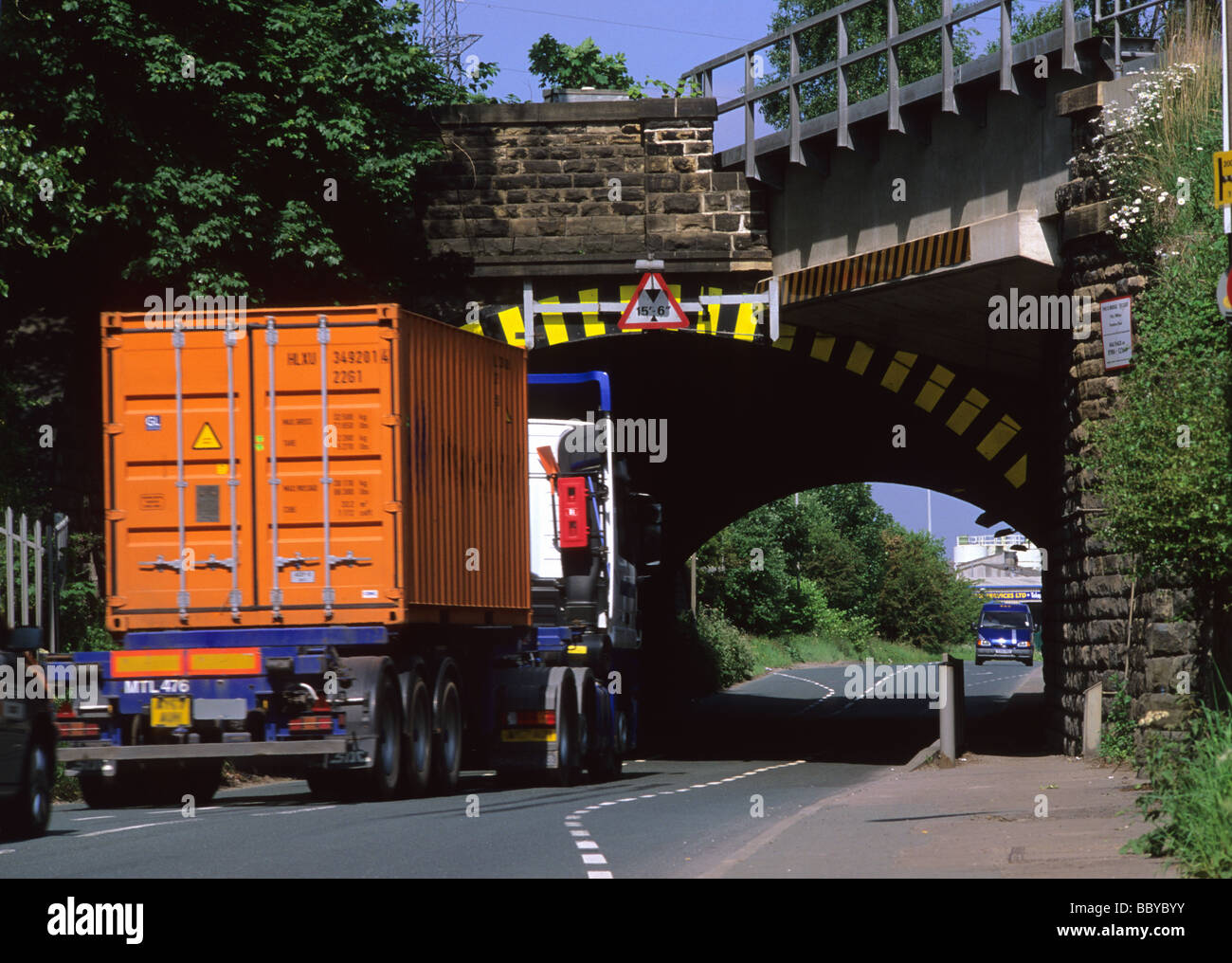 lorry passing under low railway bridge leeds uk Stock Photo - Alamy